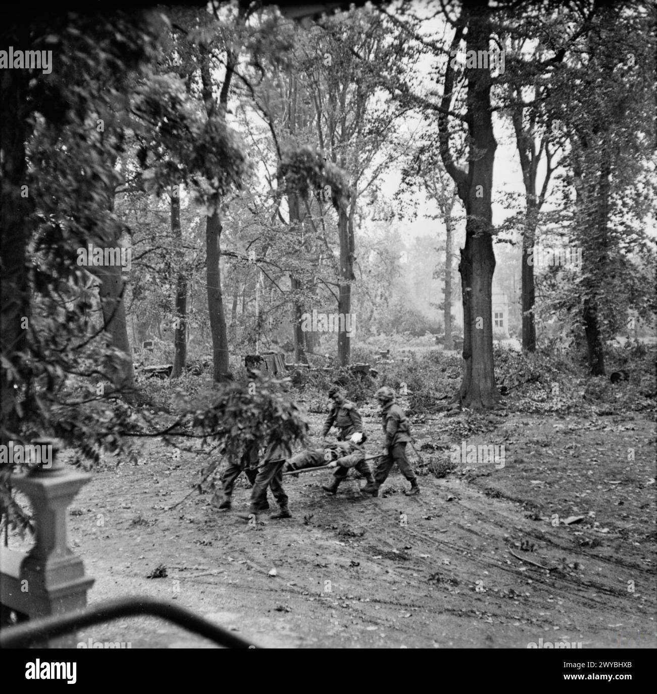 A wounded soldier is carried on a stretcher from the Divisional ...