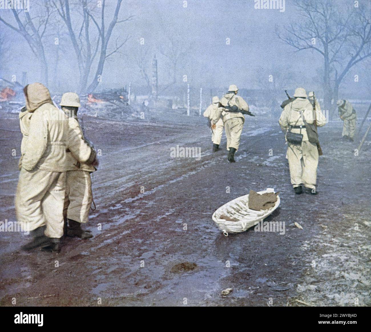 A German infantry unit wearing snow camouflage clothing pulls a white ...