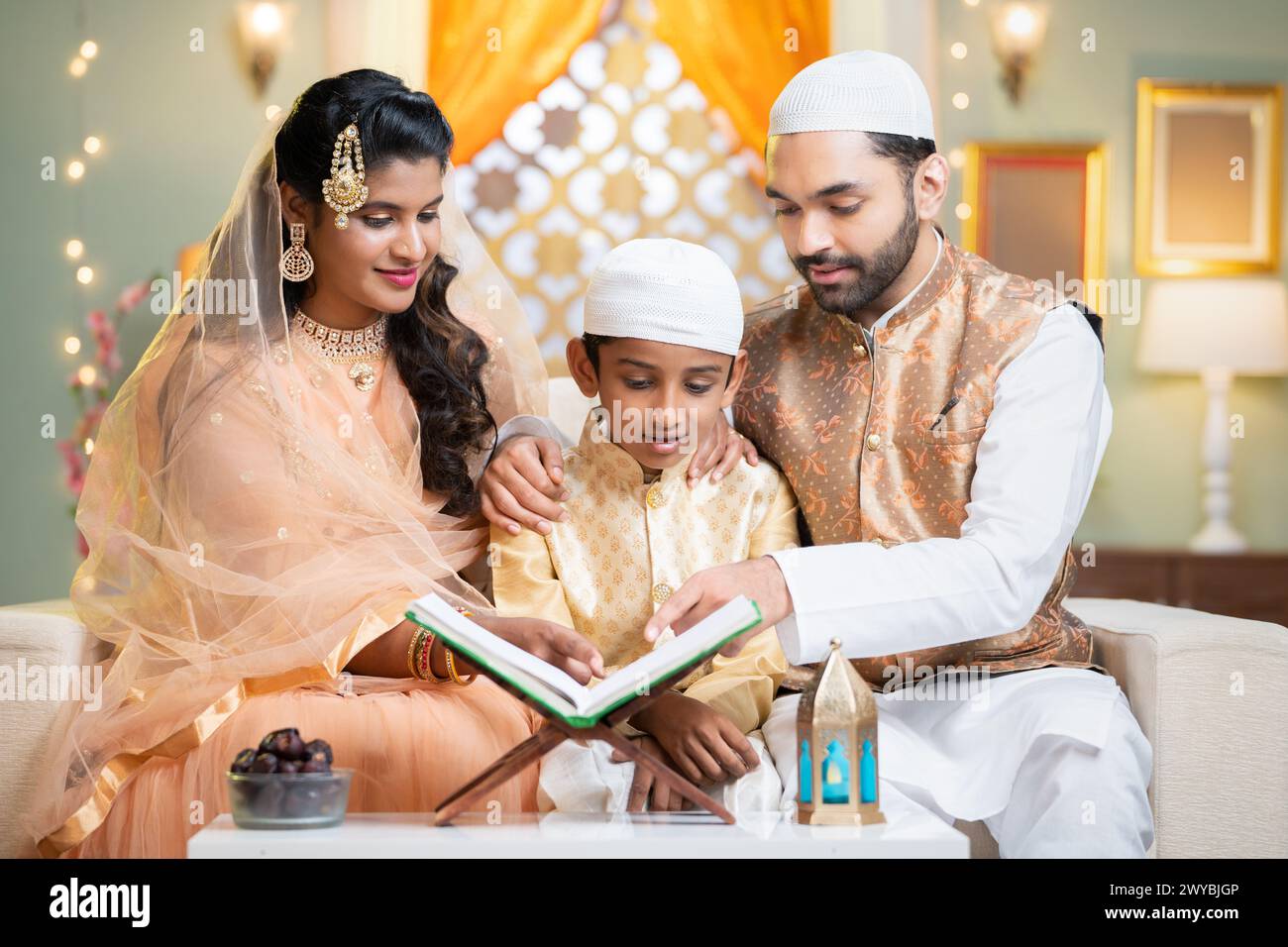 Indian muslim parents helping kid to reading quran before fasting food ...