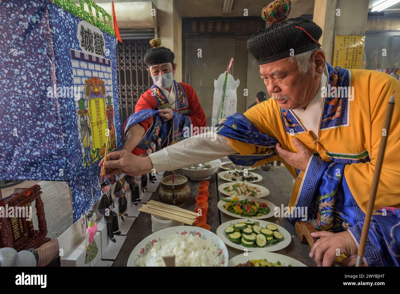 A traditional shaman performing a ritual with offerings to the ...