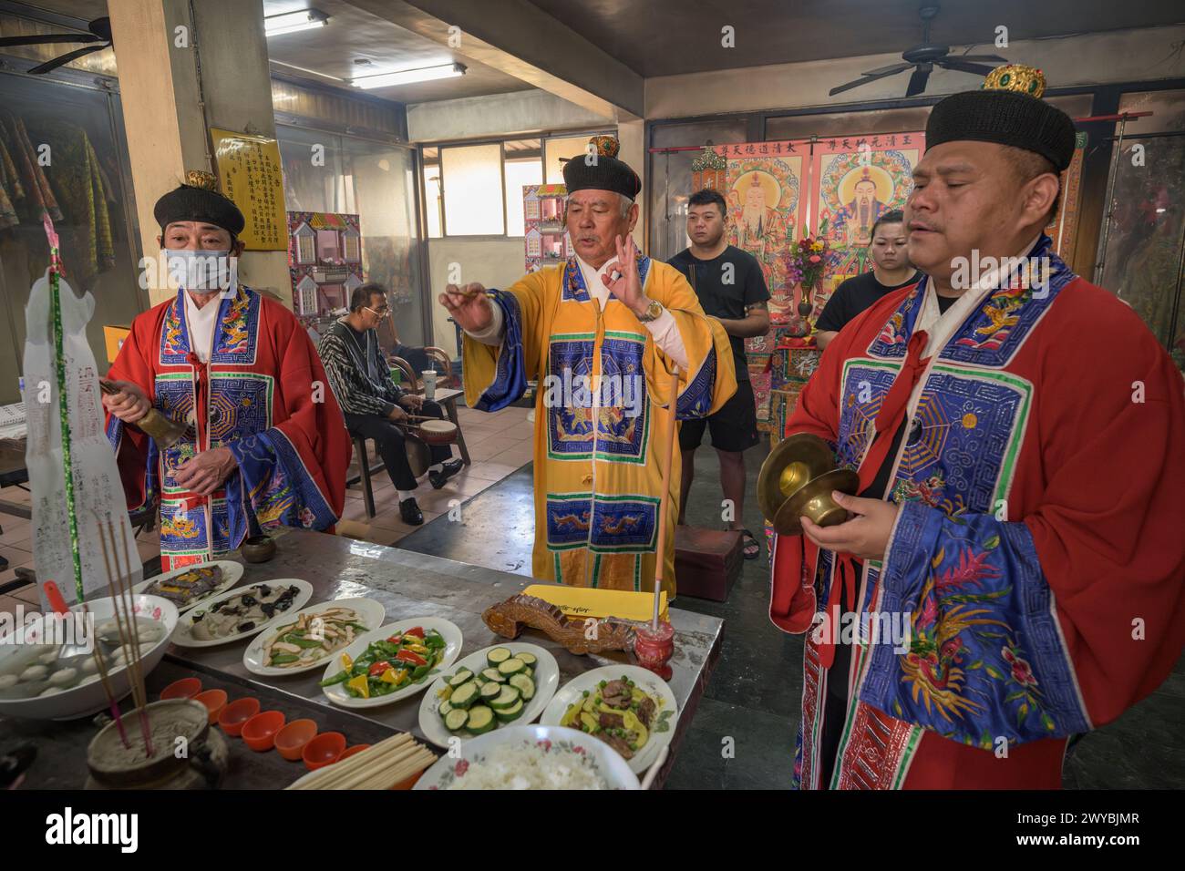 A traditional shaman performing a ritual with offerings to the ...