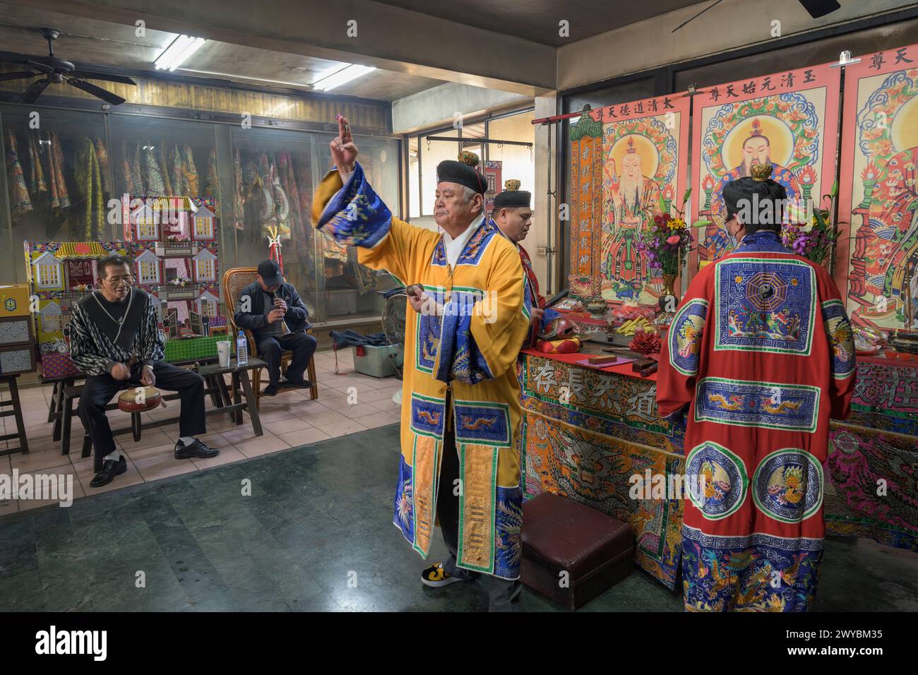 A traditional shaman performing a ritual with offerings to the ...