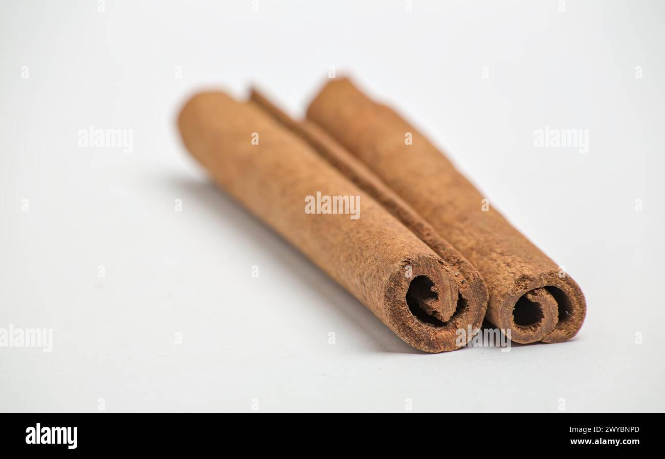 pair of cinnamon sticks next to each other (on top, cut out) isolated ...
