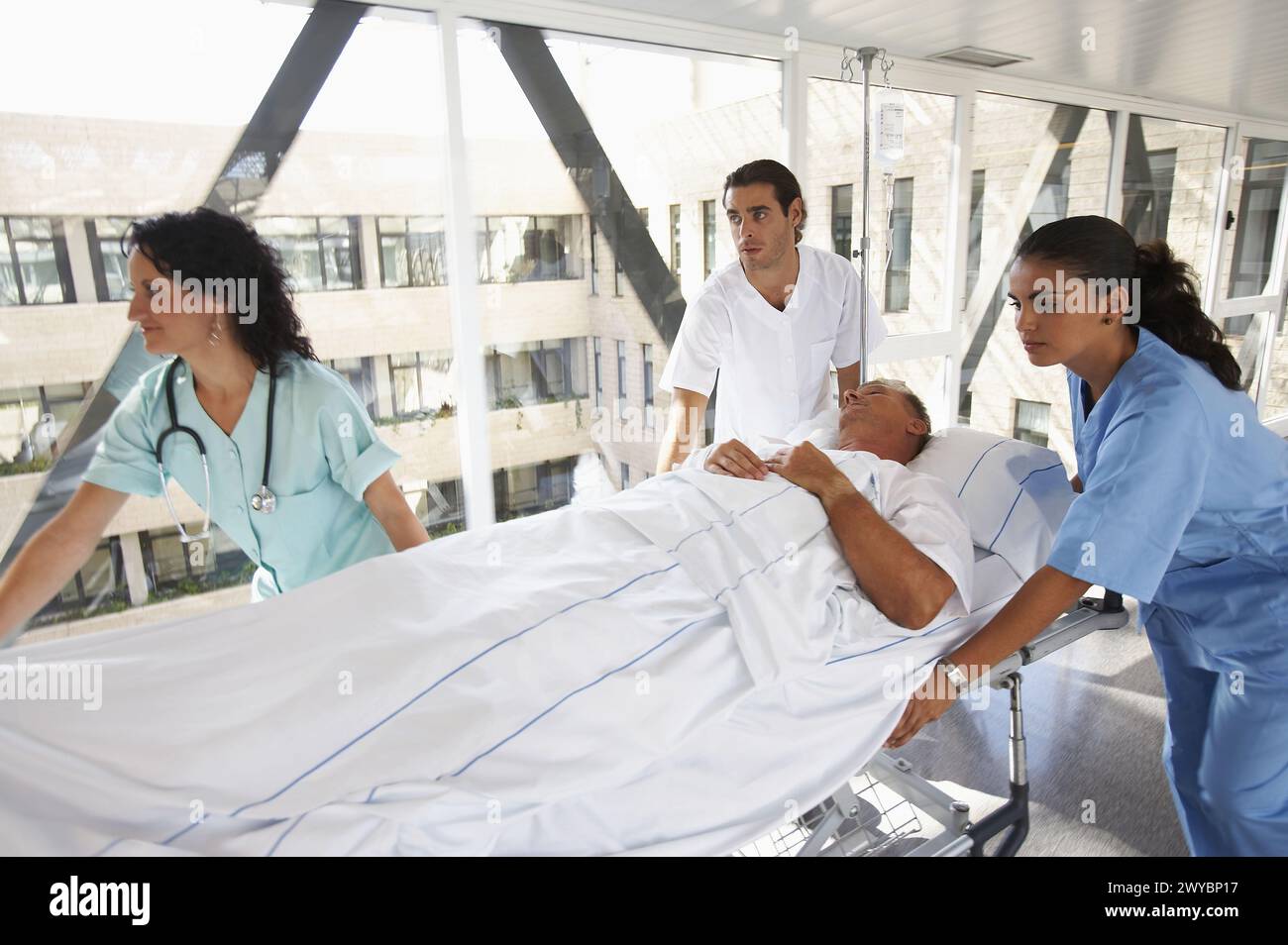 Nurses carrying patient Stock Photo - Alamy