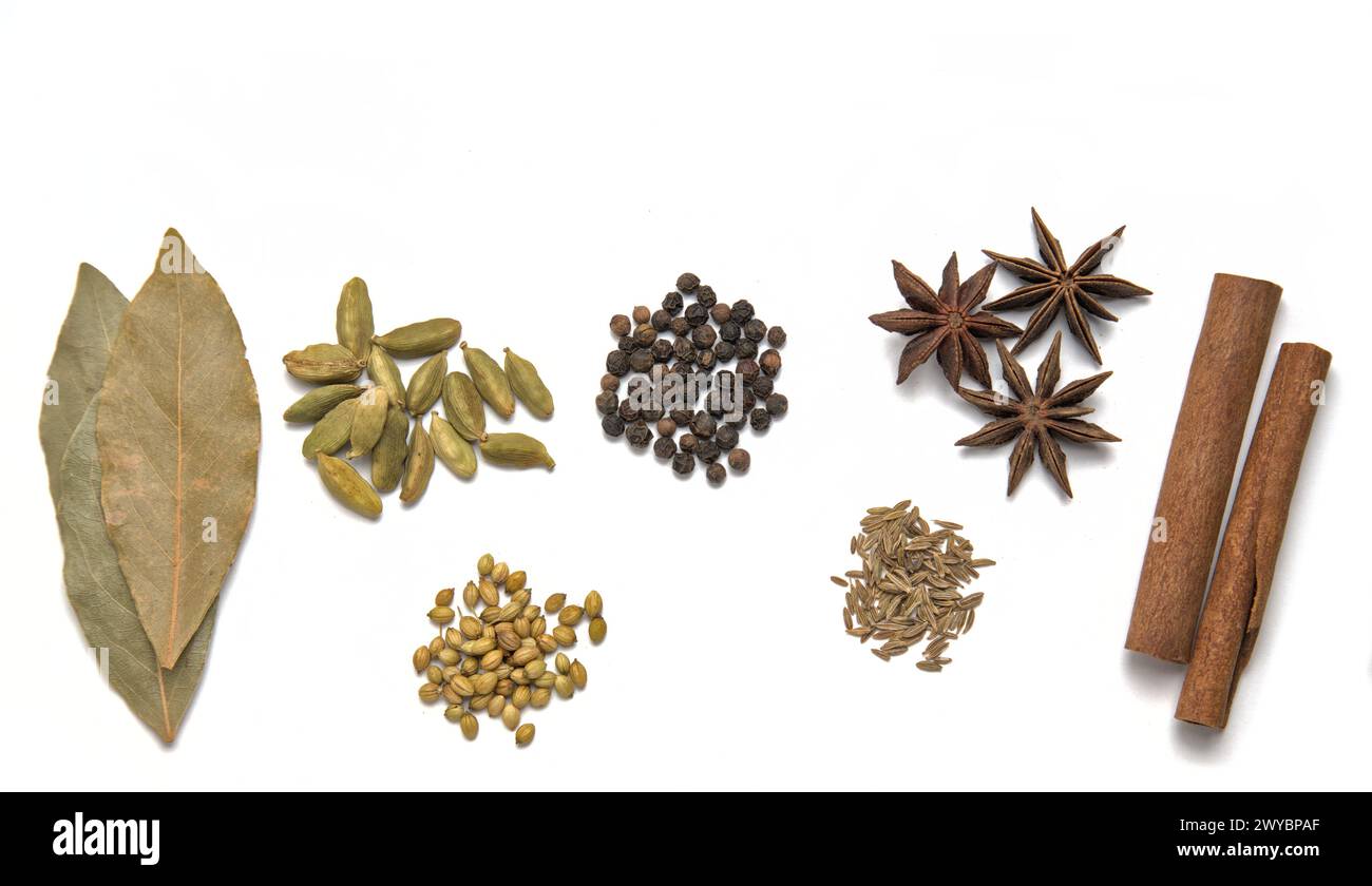 assorted spices isolated on a white background including bay leaves ...