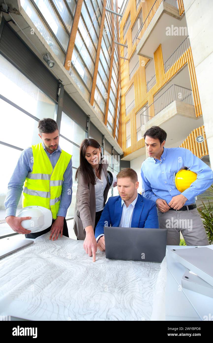 Engineers looking at map Stock Photo - Alamy