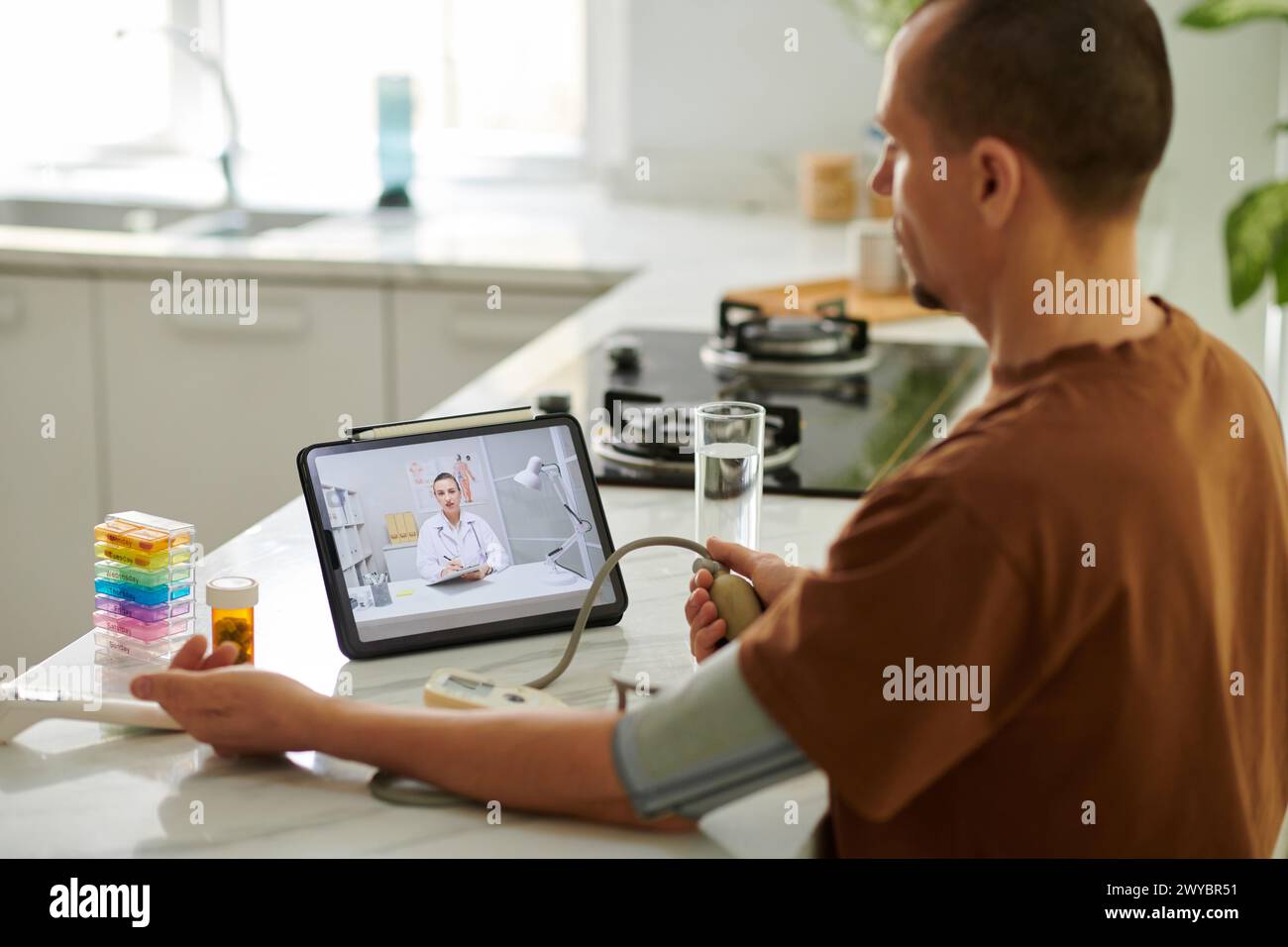 Sick man with hypertension measuring blood pressure when talking to ...