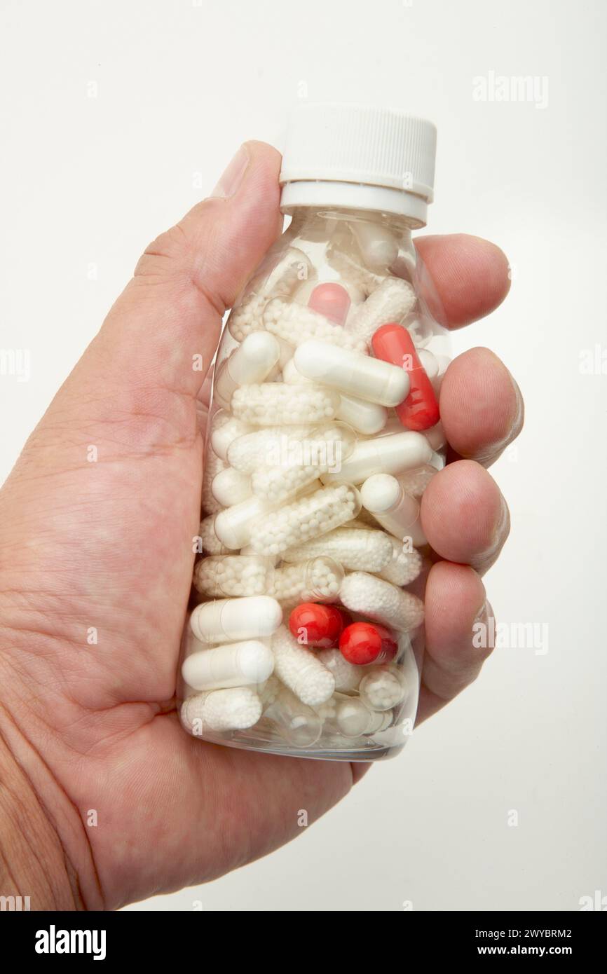 Sample different colored capsules filled with powder and pellets ...