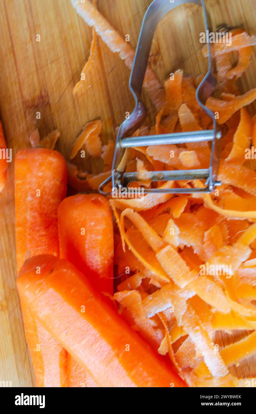 Whole and chopped carrots on chopping board hi-res stock photography ...