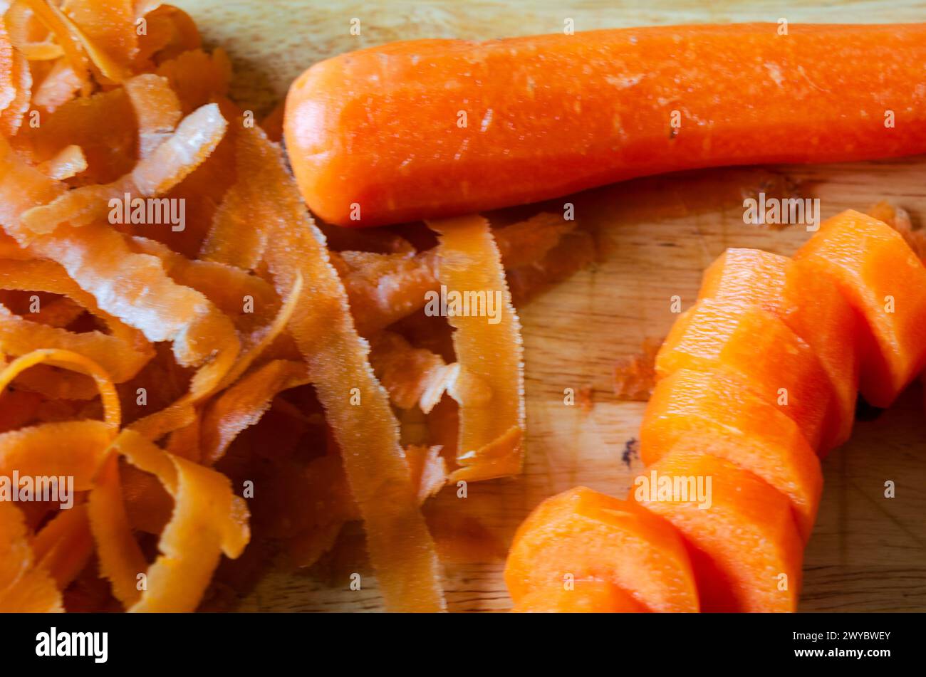 Whole and chopped carrots on chopping board hi-res stock photography ...