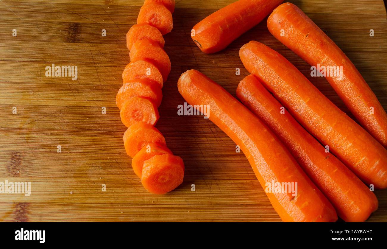 Whole and chopped carrots on chopping board hi-res stock photography ...