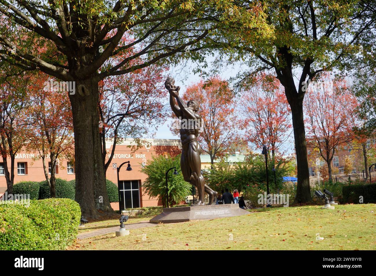 Bronze statue of MLK Jr., arms raised, at the MLK National Historical ...