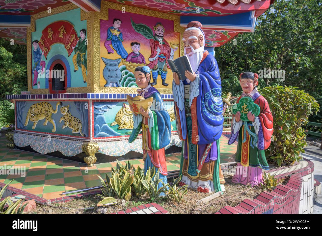 Vibrant and colorful Chinese temple with detailed figurines depicting a ...