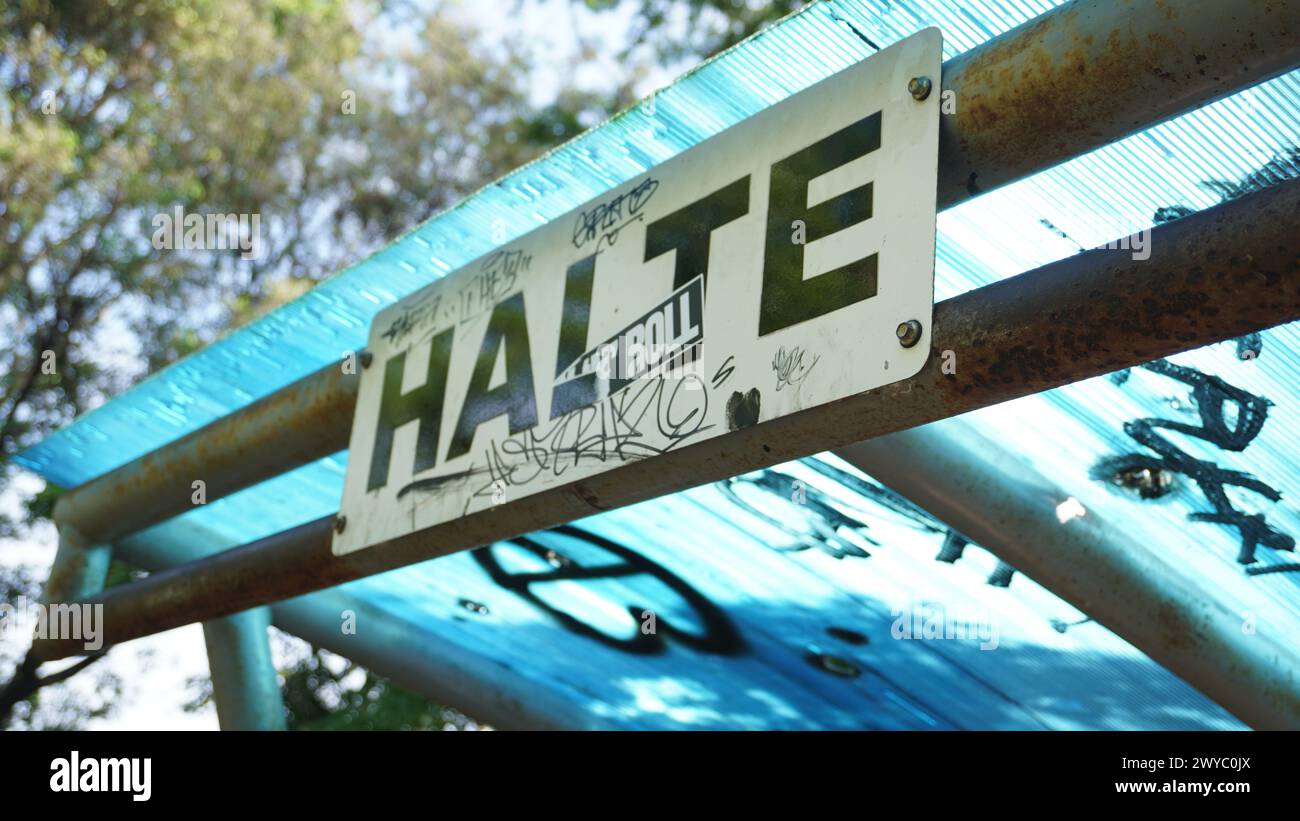 Halte inscription in Indonesian on a garden that has been scribbled on ...