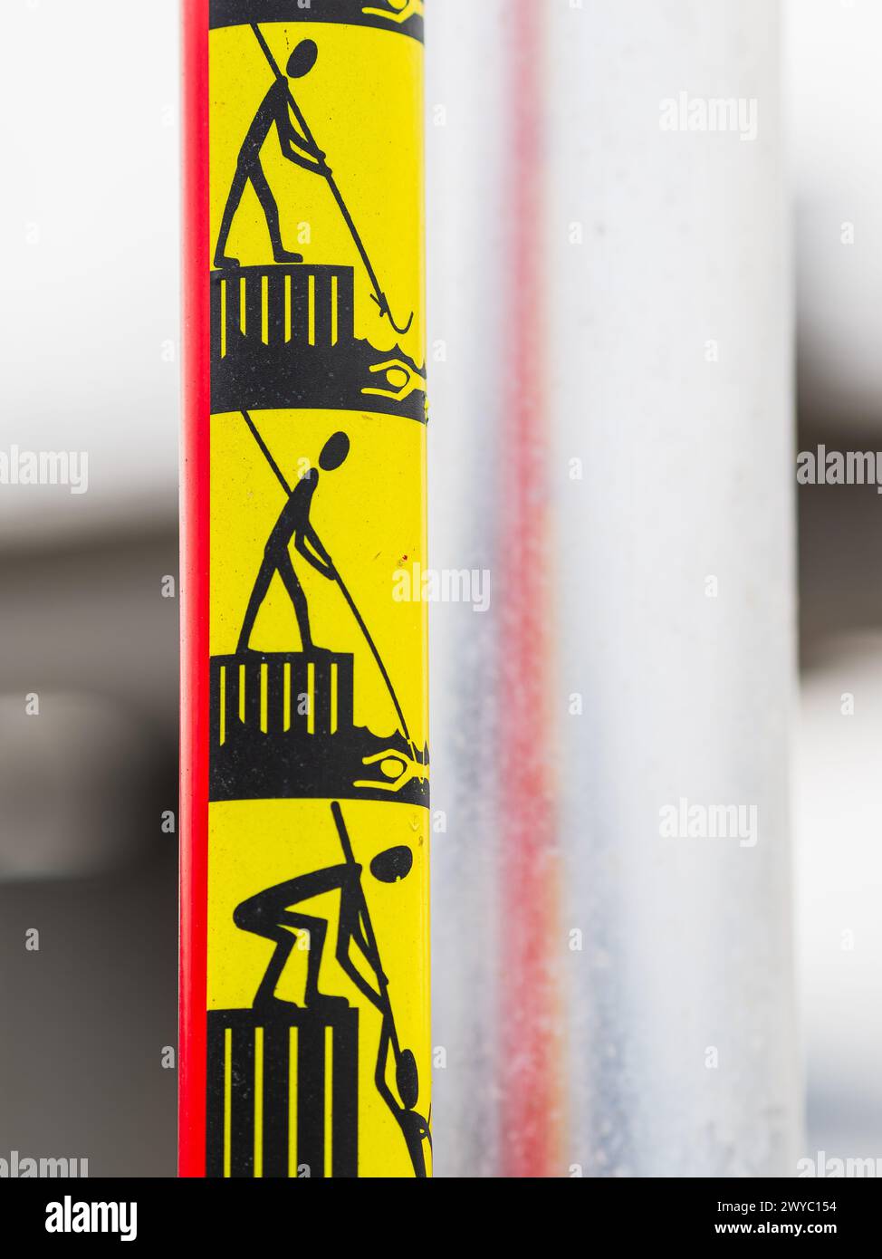 A detailed view of a yellow label with black pictograms showing step-by ...