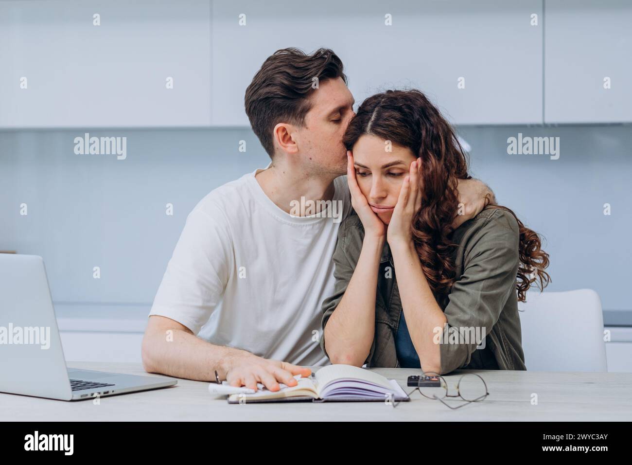 In a touching display of support, a man comforts his partner who ...