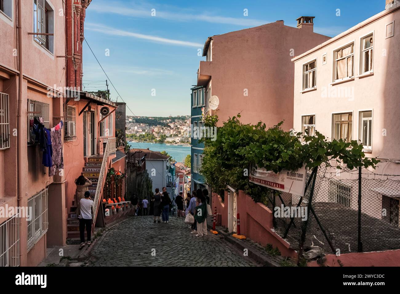 a street in the picturesque Balat district in Istanbul, full of ...