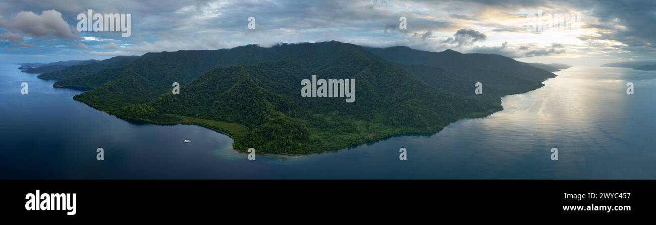 Thick rainforest covers the scenic coast of southern Batanta, Raja ...