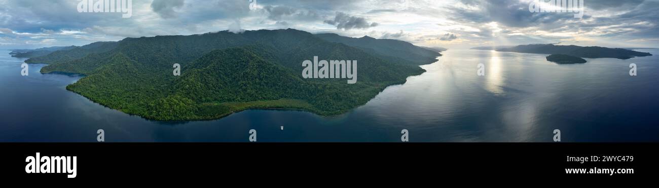 Thick rainforest covers the scenic coast of southern Batanta, Raja ...