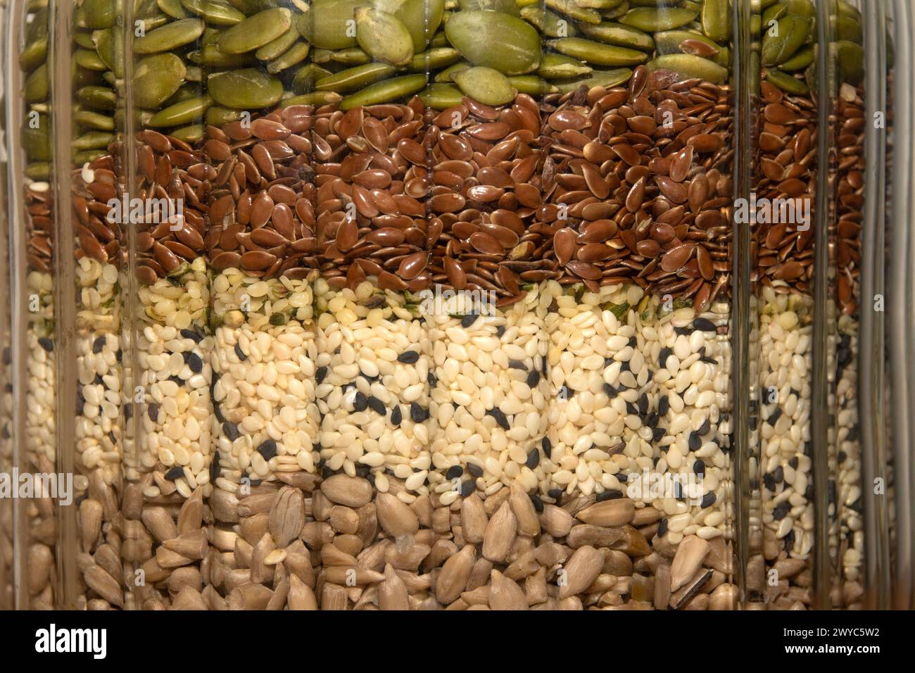 different seeds in lines in a glass container Stock Photo - Alamy