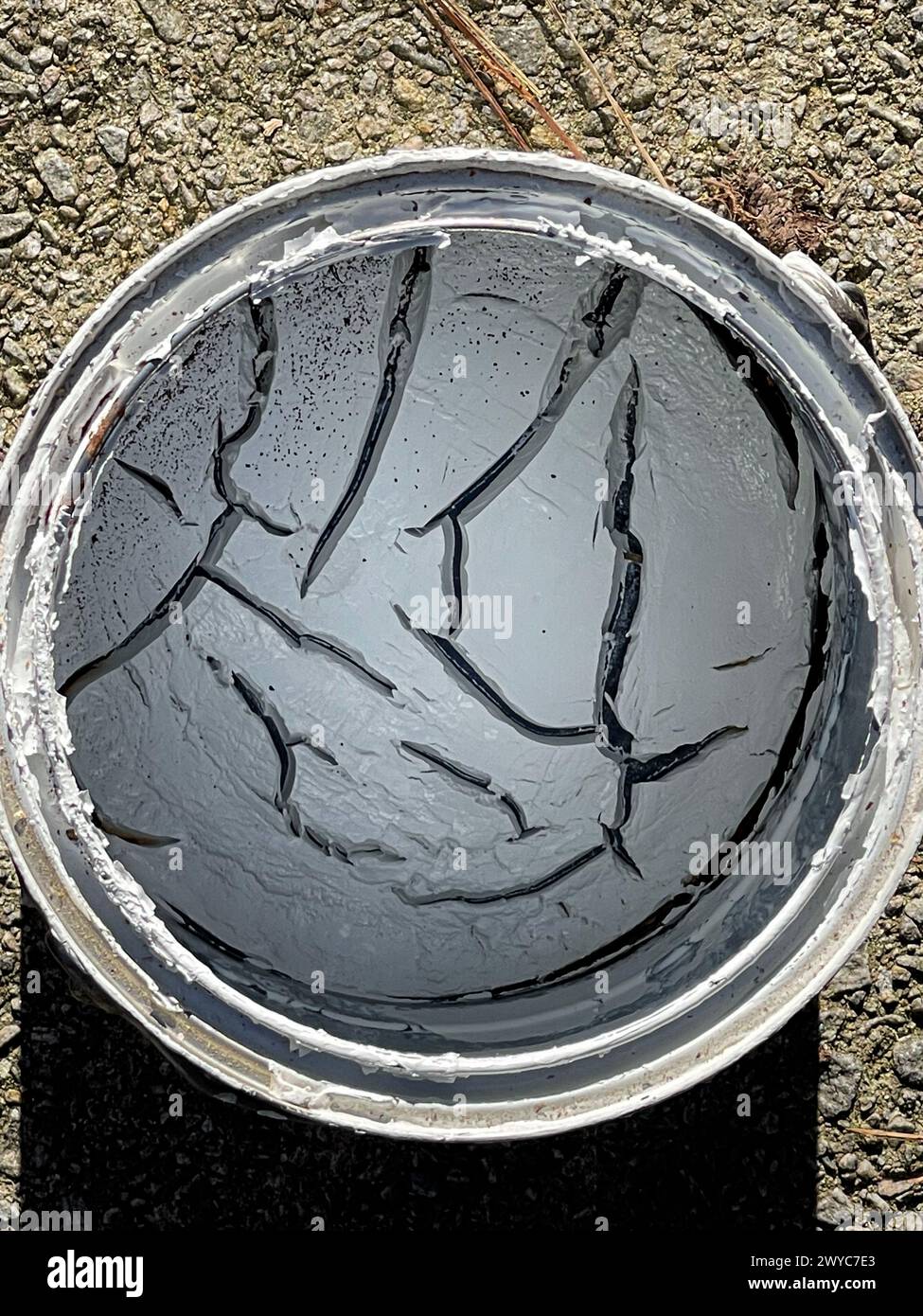 A bucket of hardened, dried out paint creates an interesting textured ...