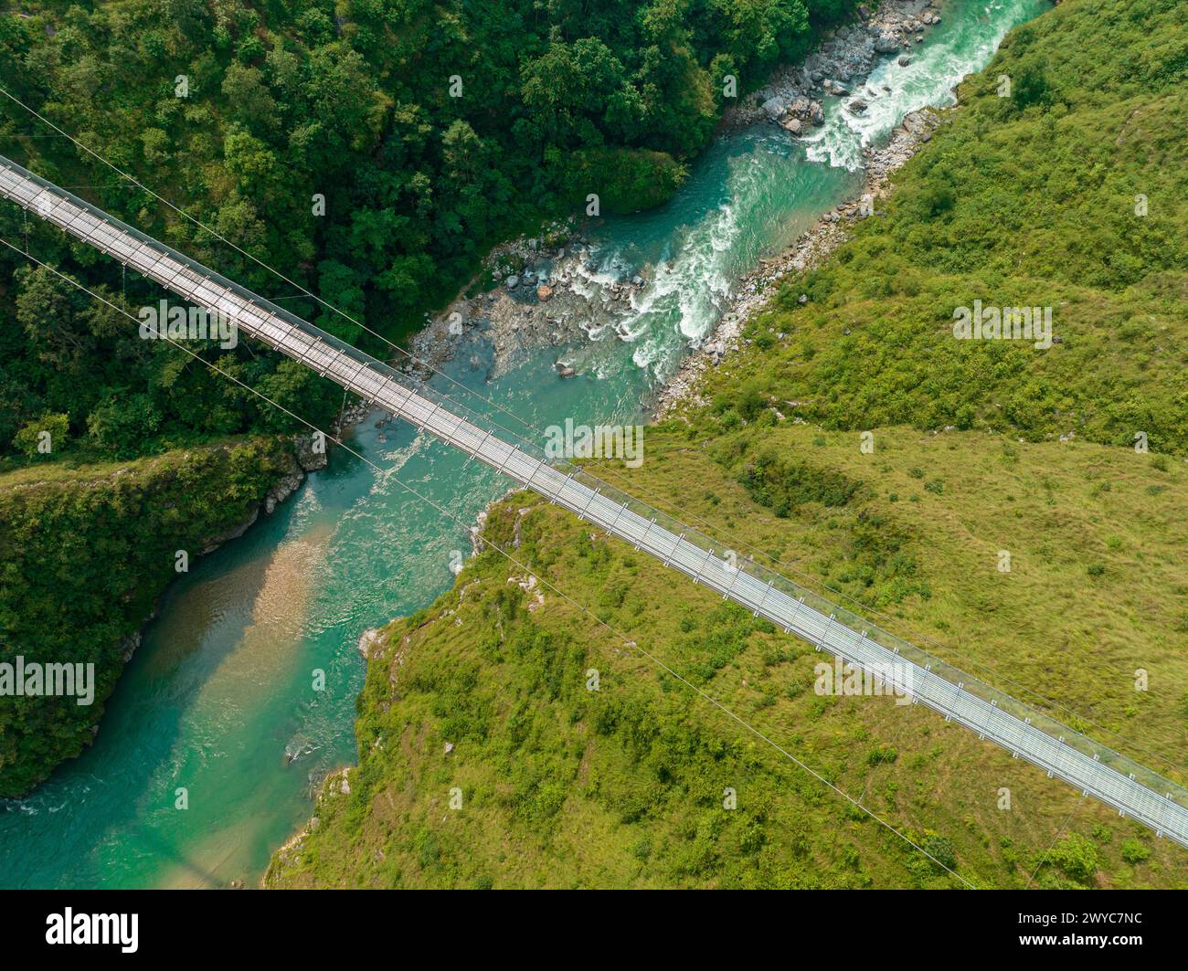 Aerial view of a Tibetan suspended bridge in Nepal is a primitive type ...