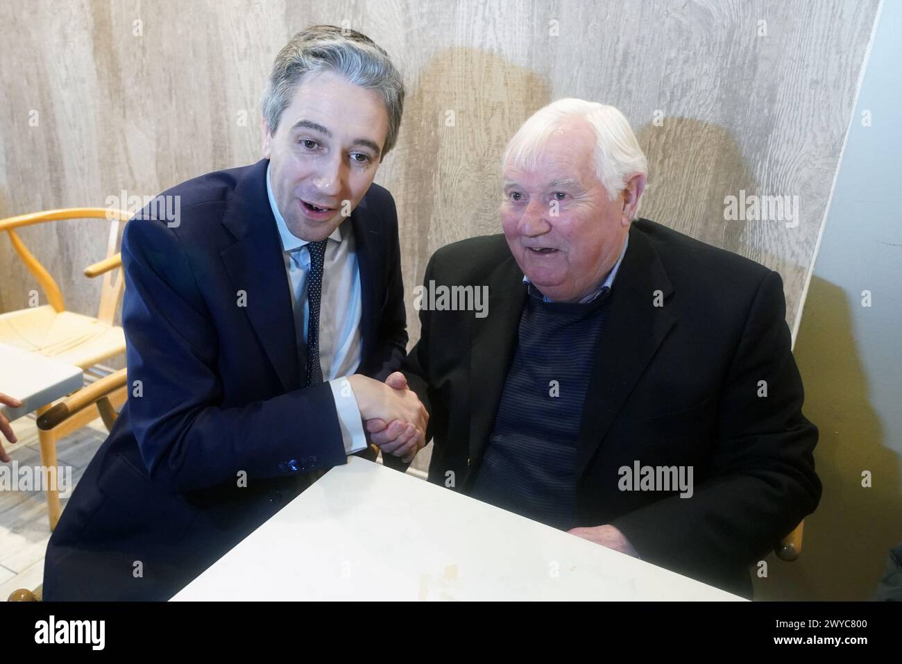 Fine Gael leader Simon Harris (left) speaks to Frank McHugh in Mocha ...