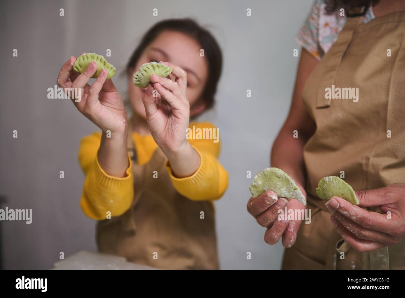 Details on sculpted dumplings in child girl's hands. Kids learning ...