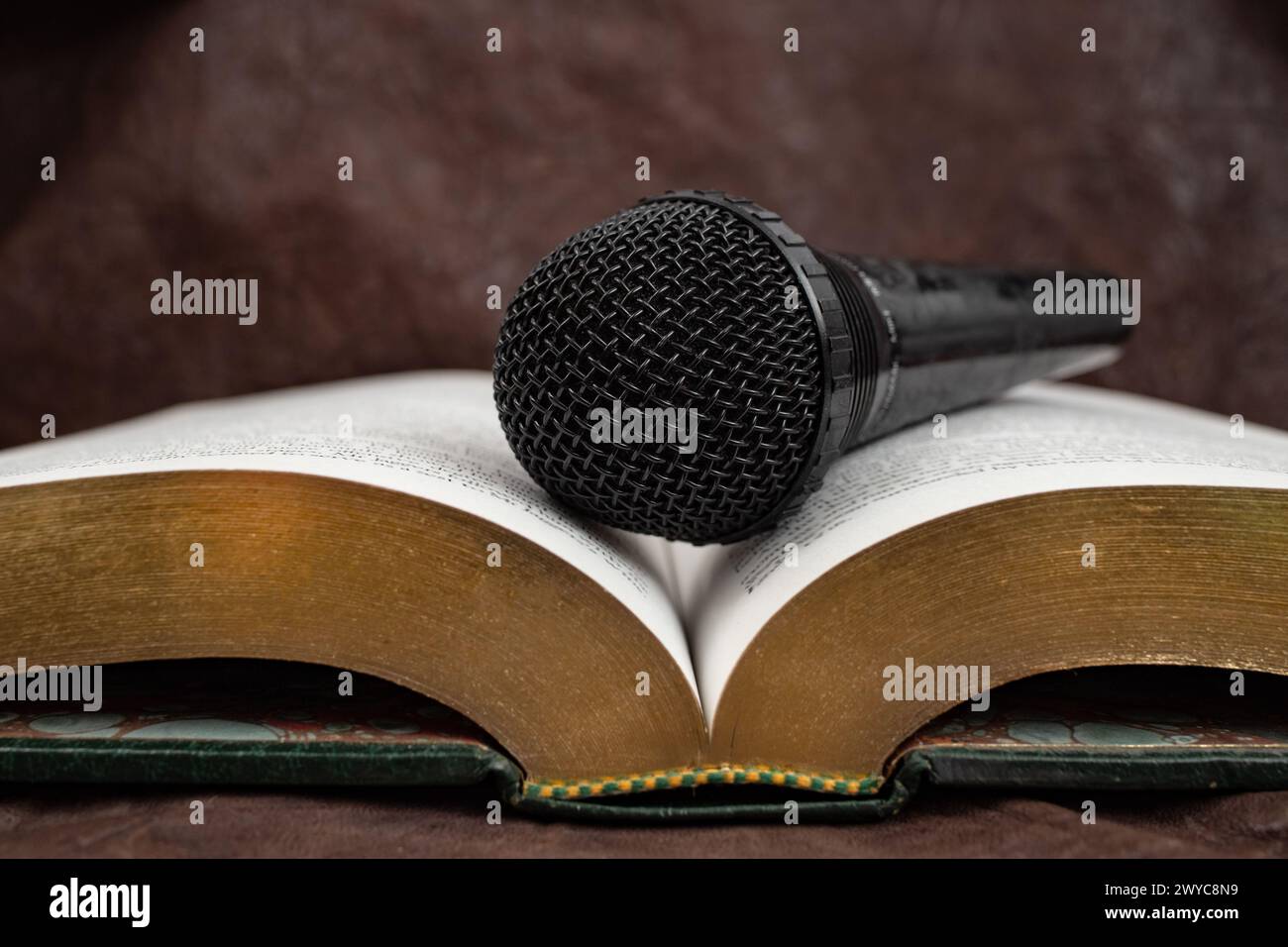 Microphone on a opened book with golden pages, audio book concept, soft ...