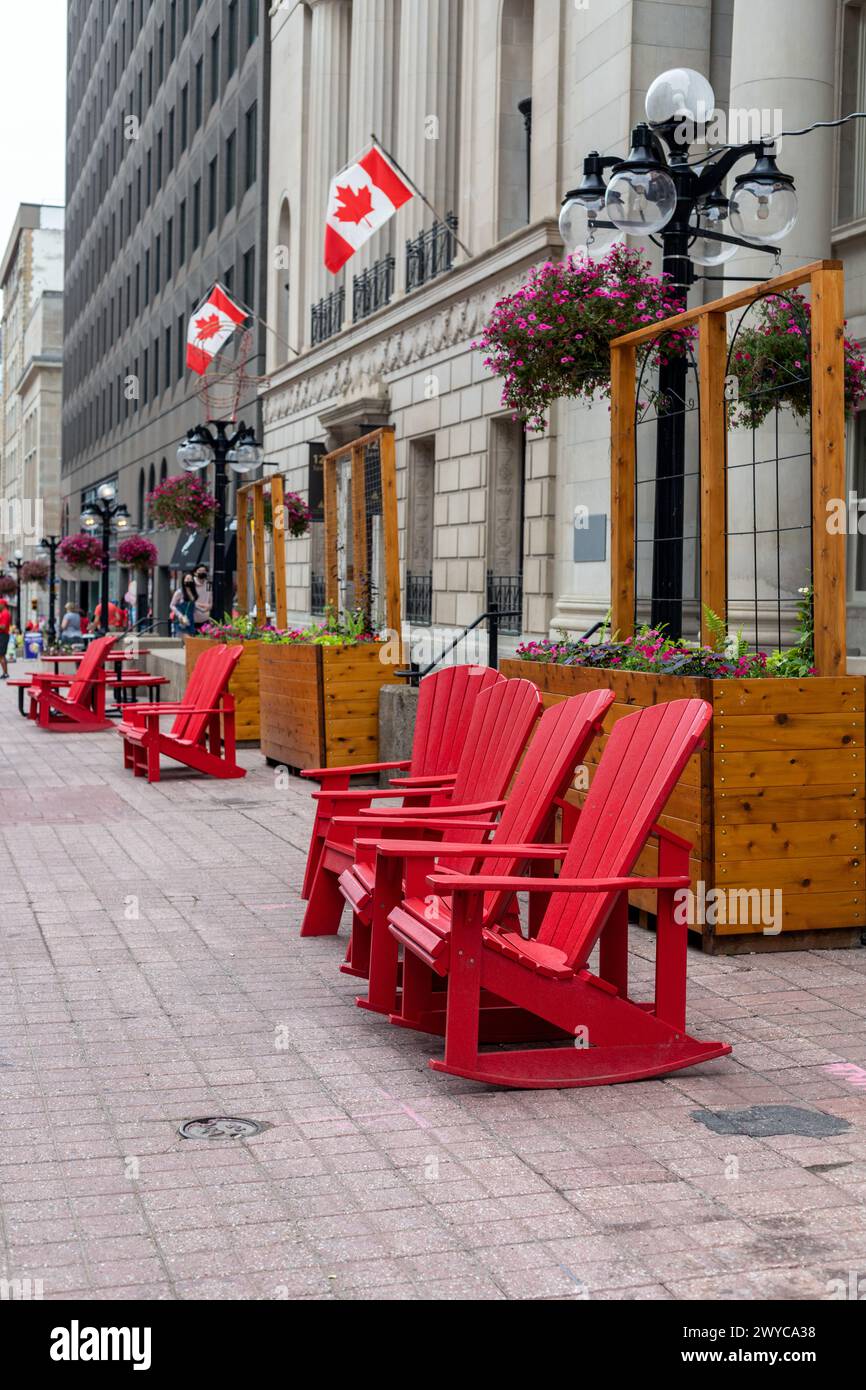 Canada, Ottawa - July 1, 2022: Red outdoor chairs and walking people in ...
