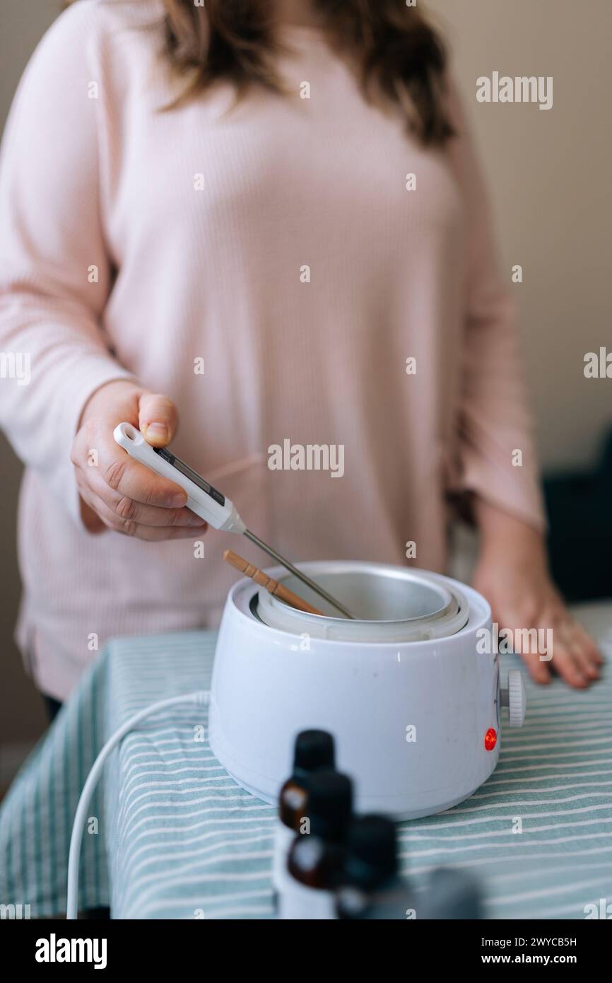 Vertical cropped shot of unrecognizable female artisan measuring ...