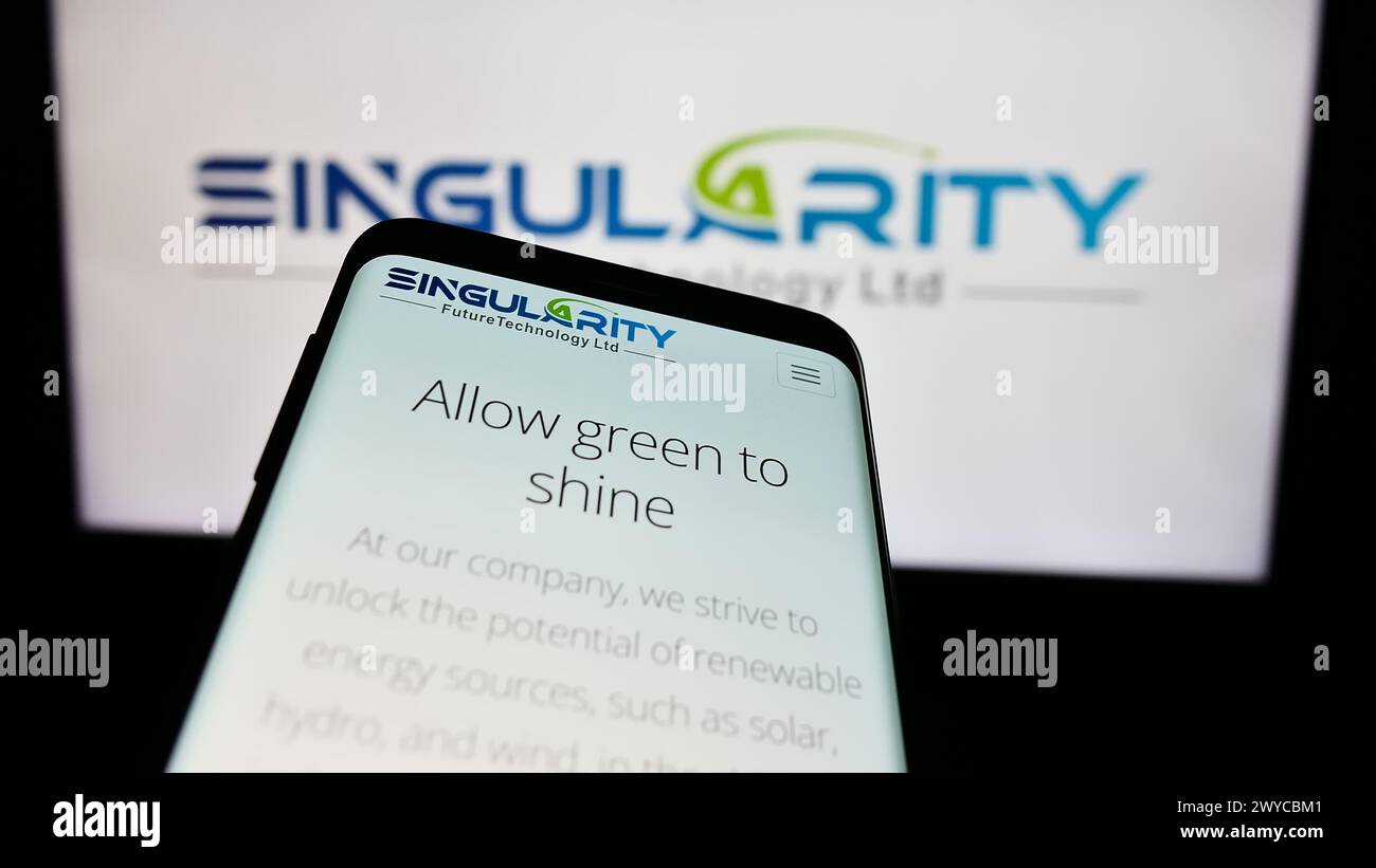Mobile phone with website of company Singularity Future Technology Ltd. in front of business ...