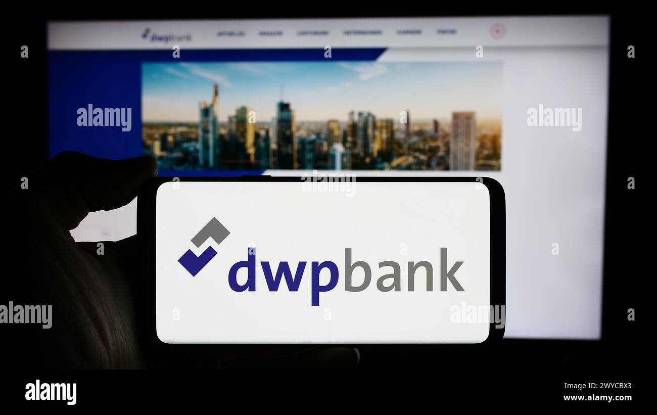 Person holding cellphone with logo of company Deutsche ...