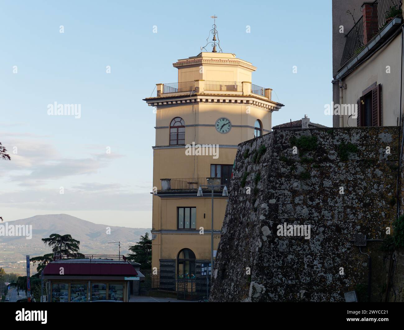 Yellow clock tower with view towards the city of Viterbo in ...