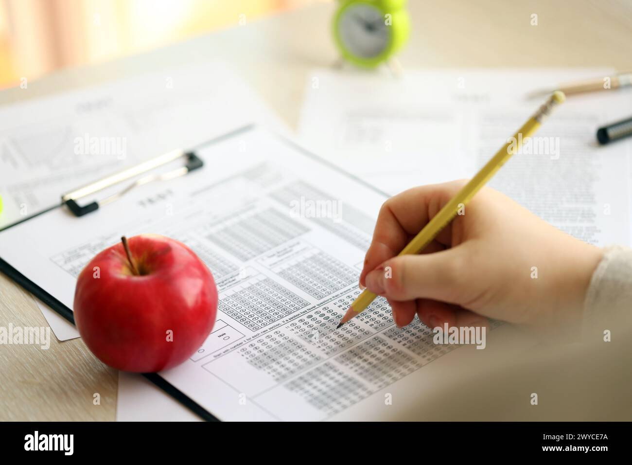 Female student hands testing in exercise and taking fill in exam paper ...