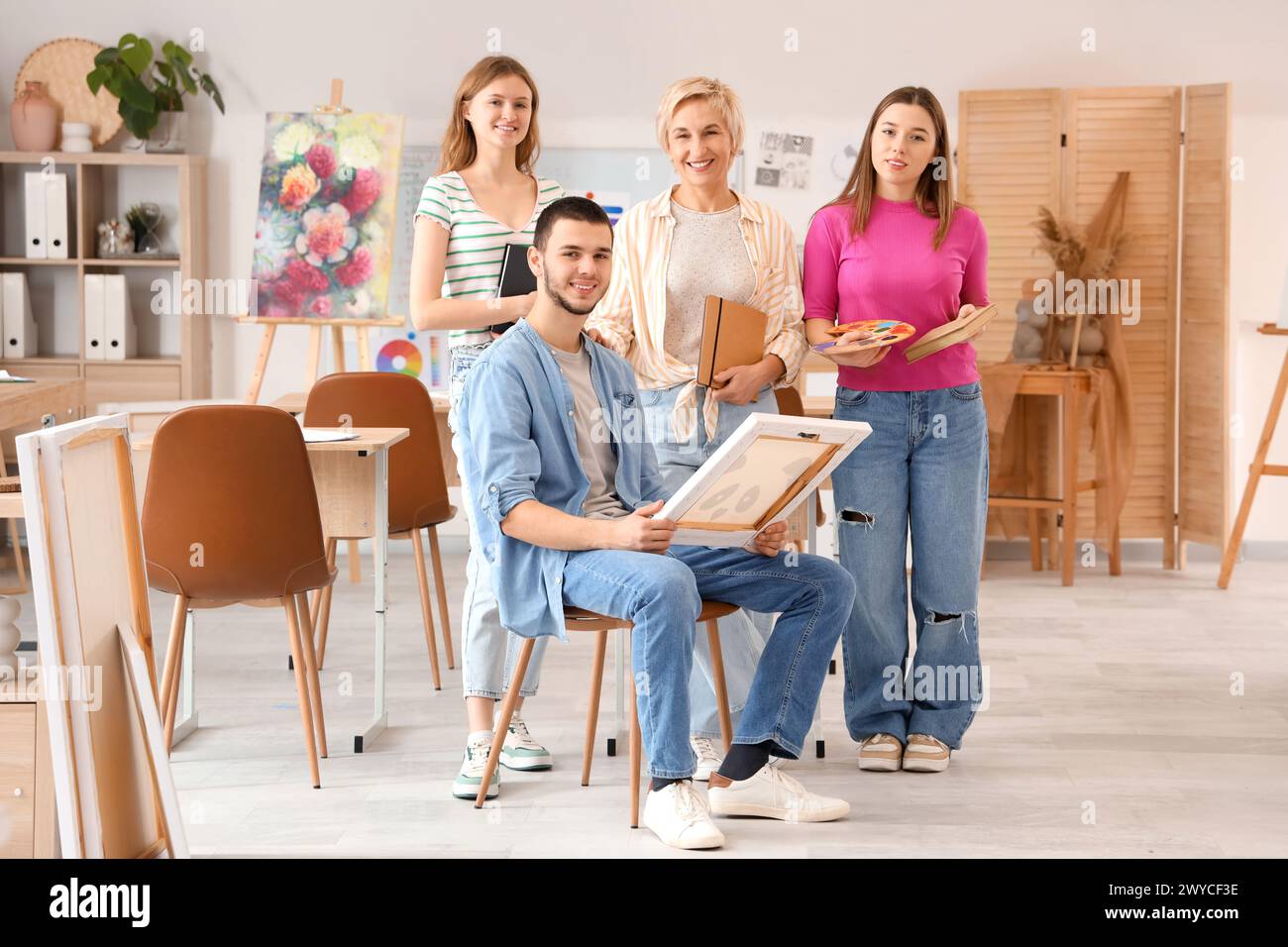 Female art teacher with students at school Stock Photo - Alamy