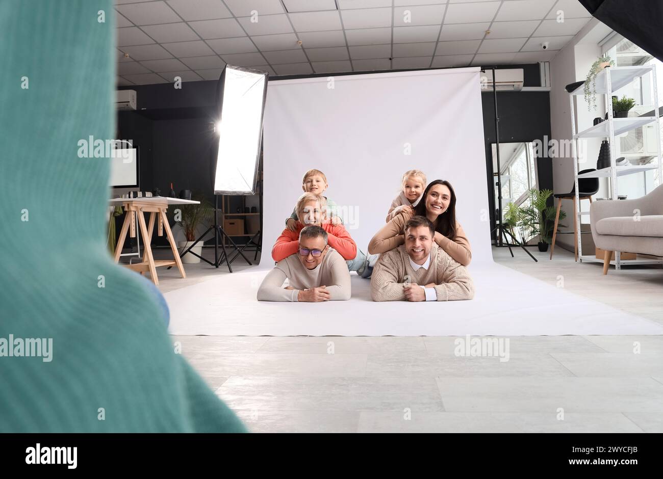 Happy family having photo shoot in studio Stock Photo - Alamy