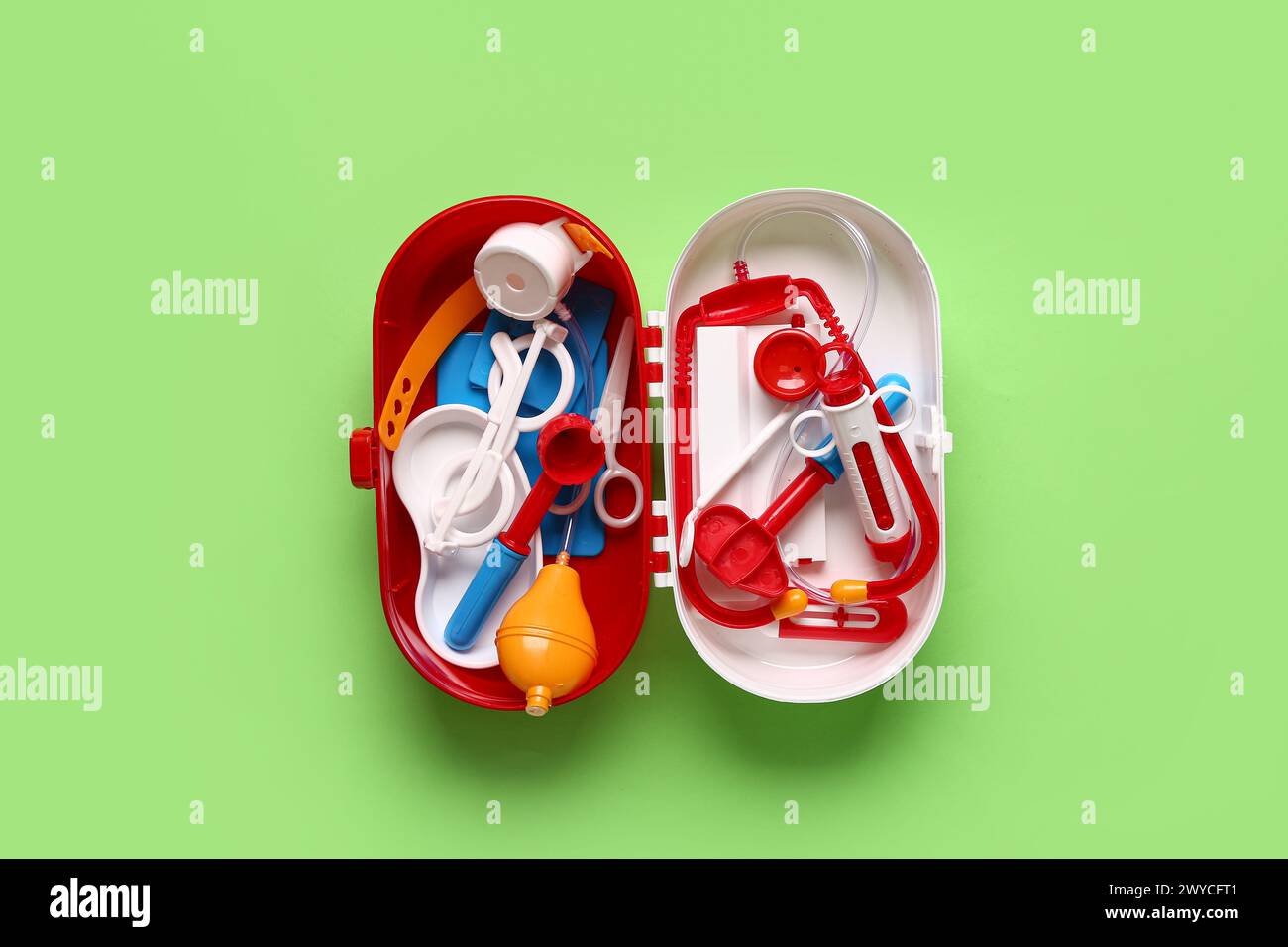 Open toy first aid kit on green background. Top view Stock Photo - Alamy