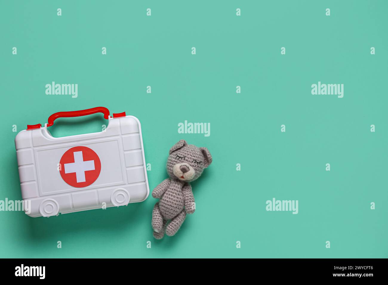 Toy first aid kit and teddy bear on turquoise background.Top view Stock ...