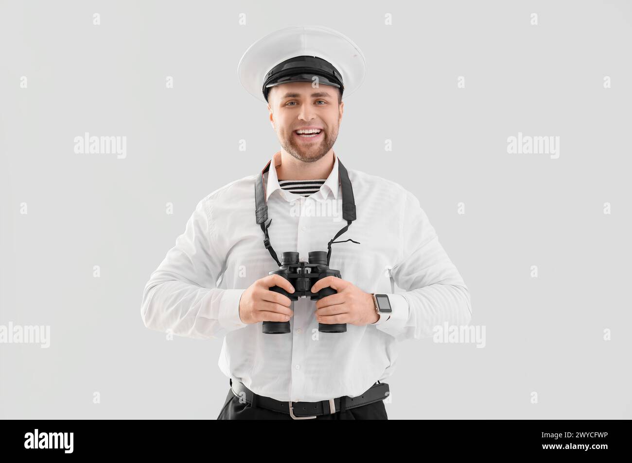 Young male sailor with binoculars on white background Stock Photo - Alamy