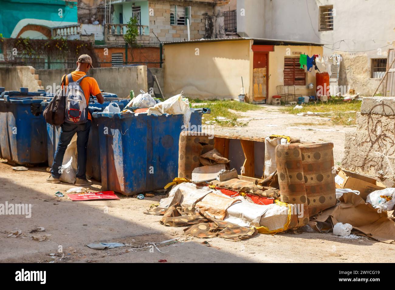 Cuban man searching in garbage bins in Havana, Cuba Stock Photo - Alamy