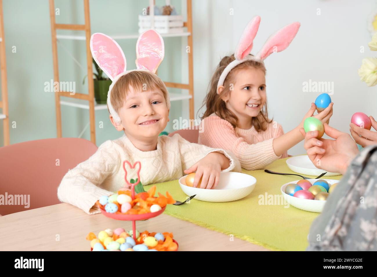 Little children breaking Easter eggs at dinner Stock Photo - Alamy