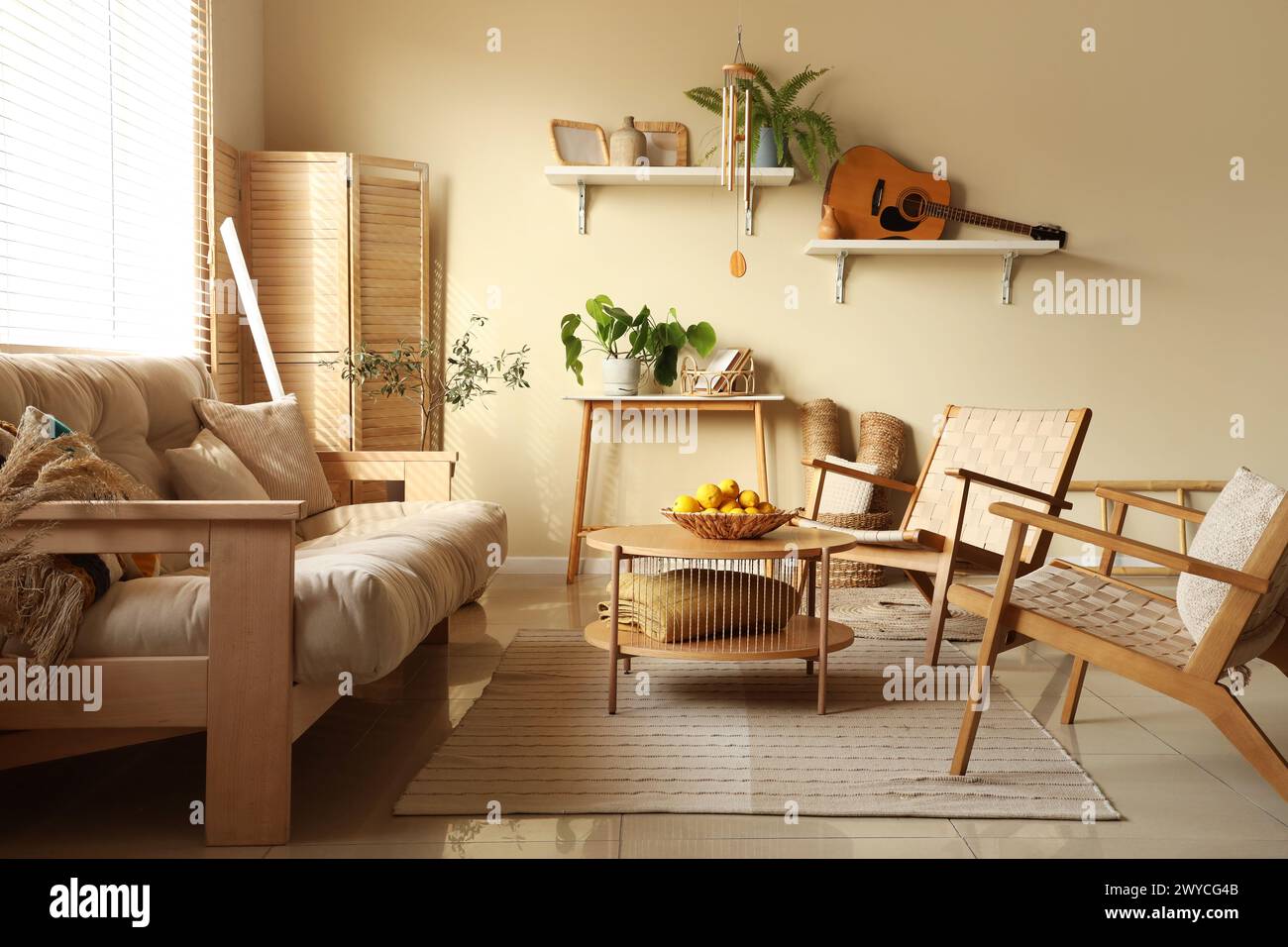 Interior of light living room with wind chime, sofa and armchairs Stock ...