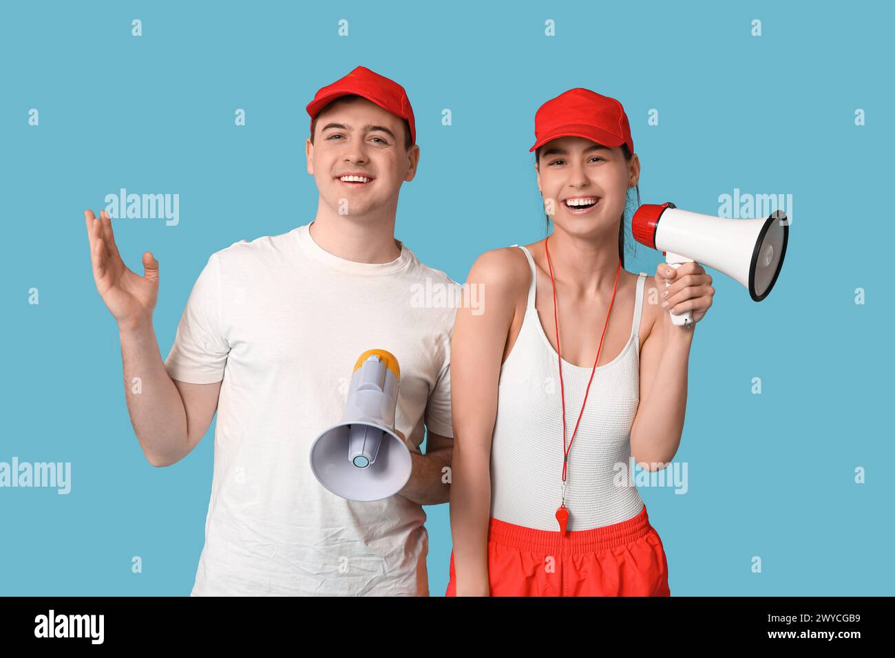 Lifeguards with megaphones on blue background Stock Photo - Alamy
