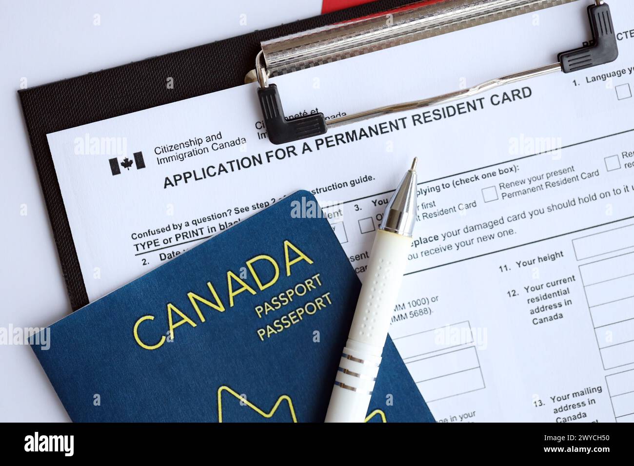 Application for permanent resident card on table with pen and canadian ...