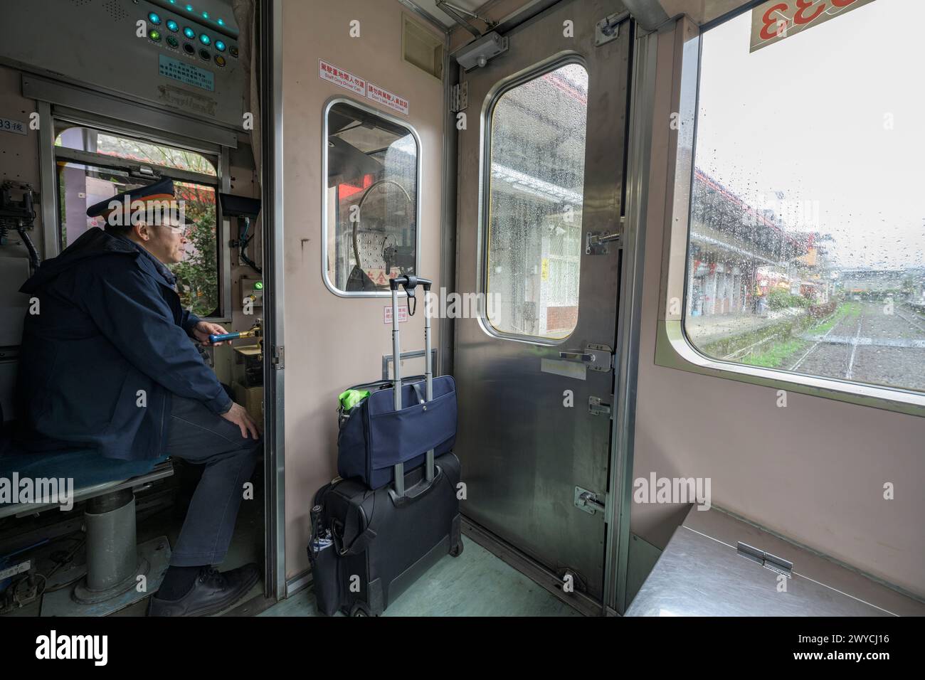 Inside view of a train driver’s cabin with a focused driver at the ...