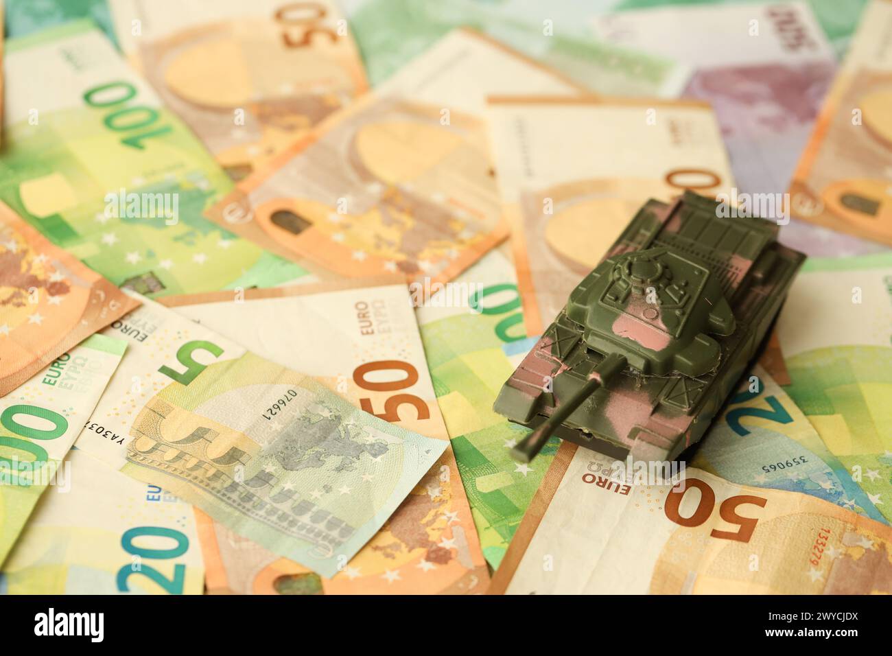 Many euro banknotes and tank. Lot of bills of European union currency ...