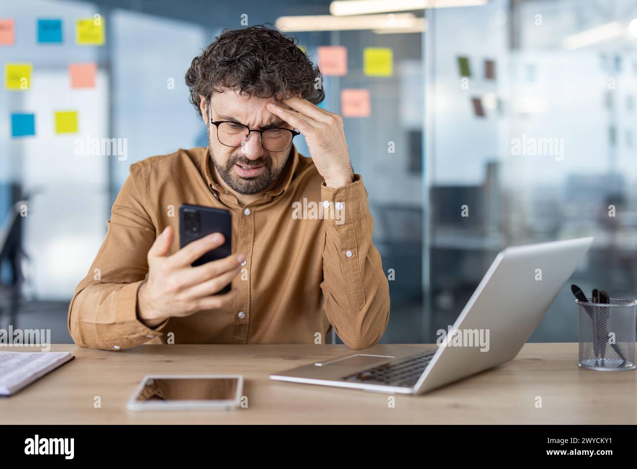 Confused hispanic business man using hi-res stock photography and ...