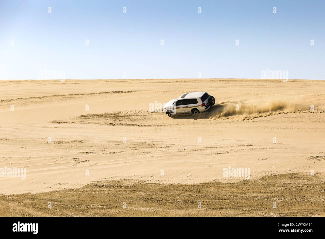 A large white cars off-road carrying tourists through the attractive ...