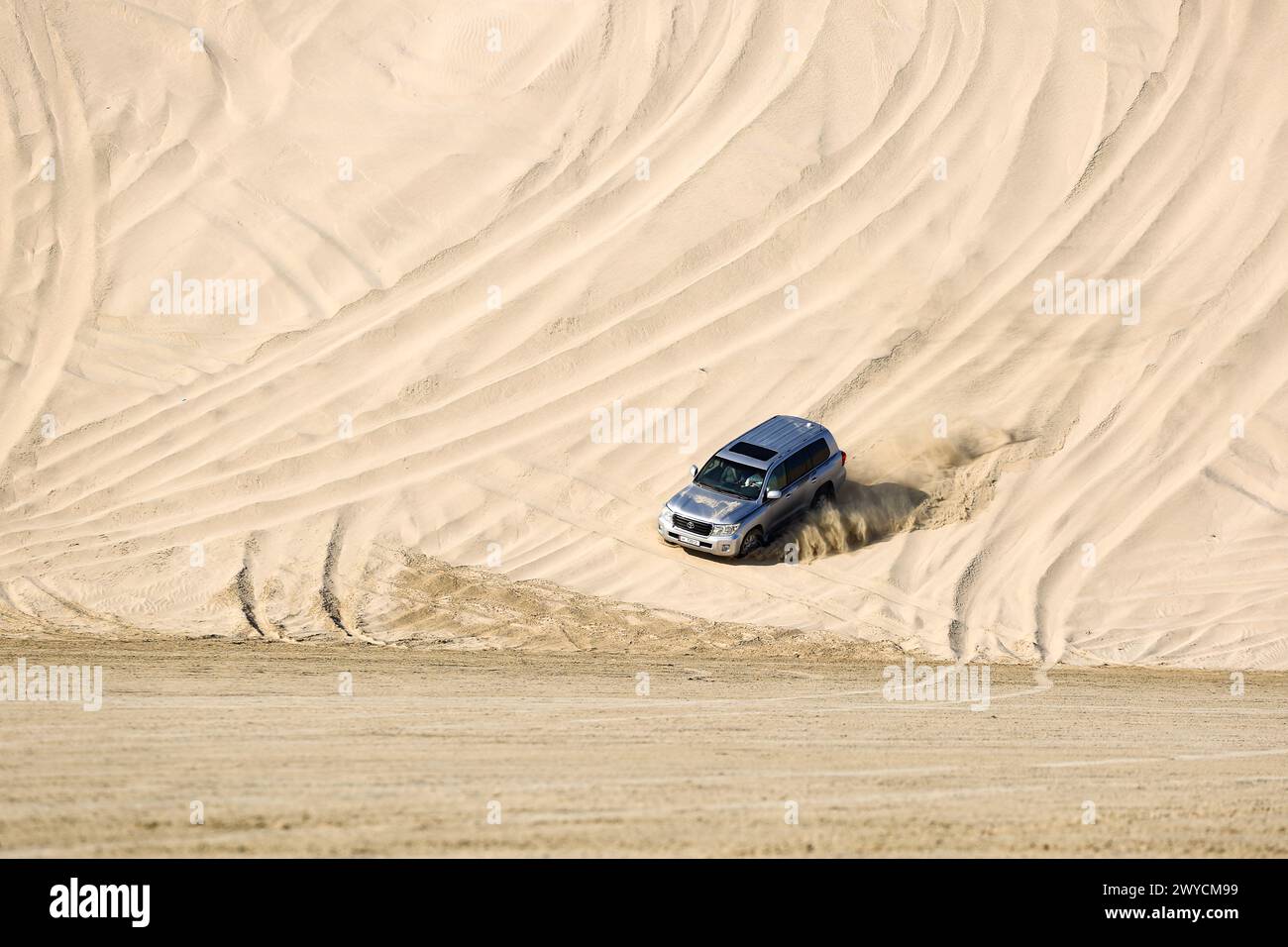 A large white cars off-road carrying tourists through the attractive ...